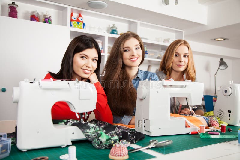 Women in a sewing workshop stock image. Image of college - 64870725