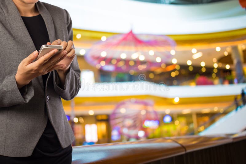 Women in Shopping Mall Using Mobile Phone. Stock Photo - Image of woman ...
