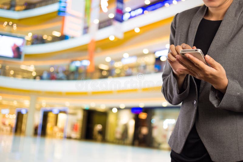Women in Shopping Mall Using Mobile Phone. Stock Photo - Image of store ...