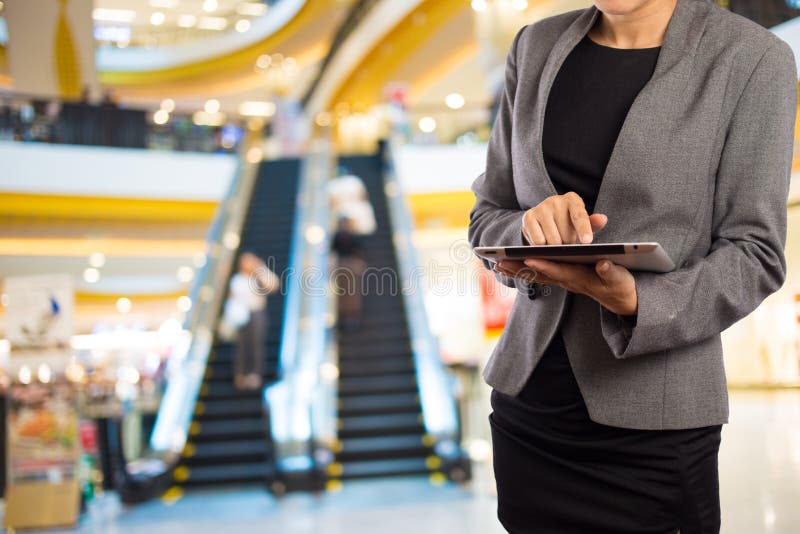 Women in Shopping Mall Using Mobile Tablet PC. Stock Photo - Image of ...