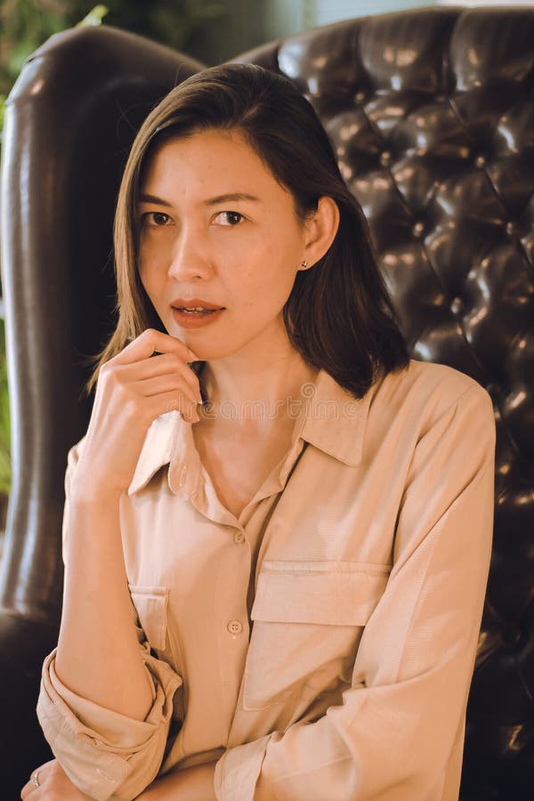 Women Sitting on a Black Leather Sofa Stock Photo - Image of legs ...