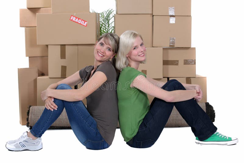 Women sitting by boxes stock image. Image of friends - 35910893