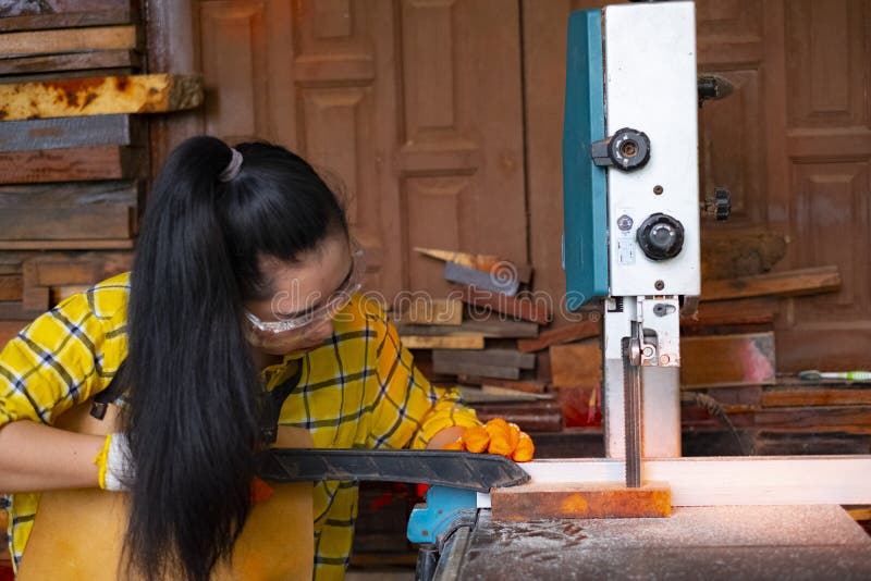 Women Standing is Craft Working Cut Wood at a Work Bench with Band Saws ...