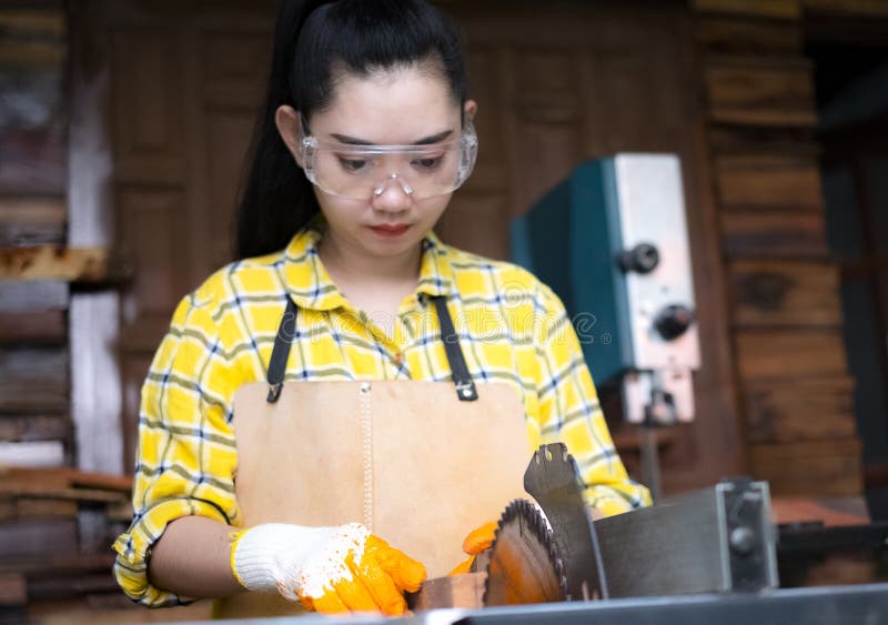 Women Standing is Craft Working Cut Wood at a Work Bench with Circular ...