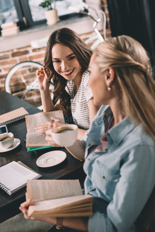 Women Students Having Conversation while Studying Together Stock Image ...