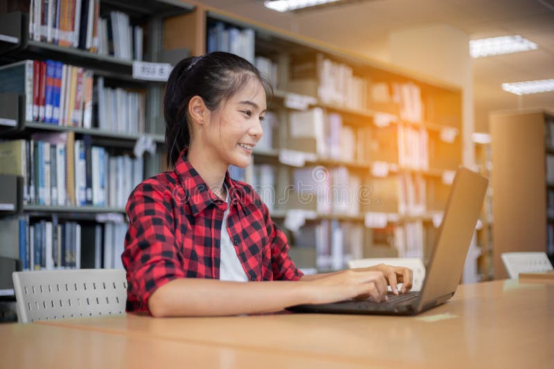 Women is Studying with Laptop at Library. Student is Doing Homework ...