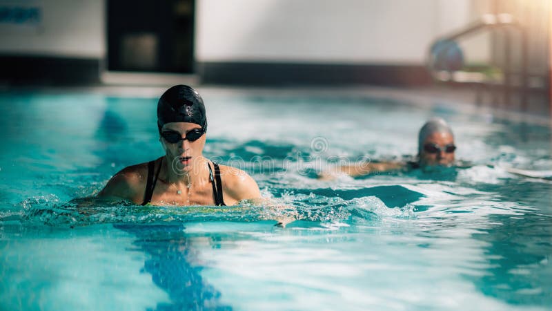 Women Swimming Together in Indoor Swimming Pool Stock Image - Image of ...