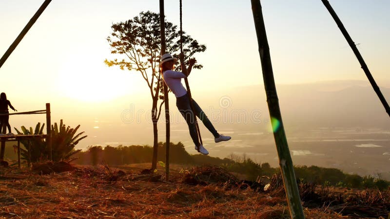 Women swing the rope. stock video. Video of girl, hanging - 98275177