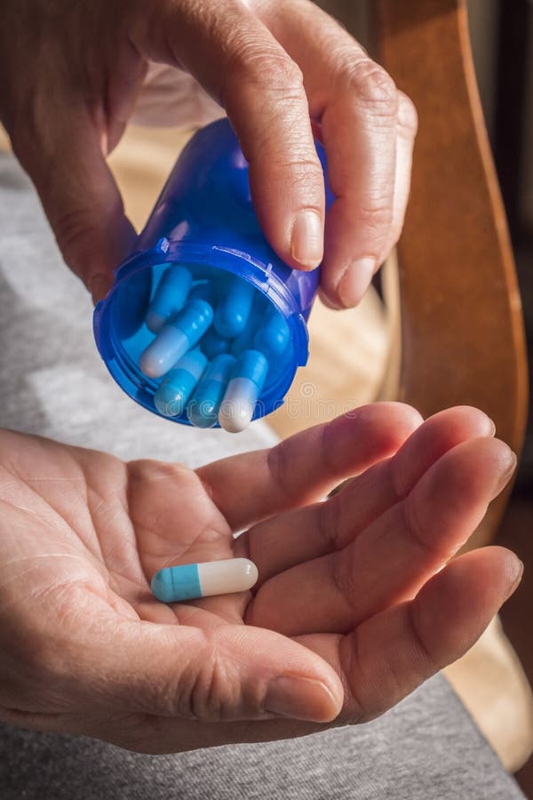 Women Take White and Blue Capsule with Right Hand Stock Image - Image ...