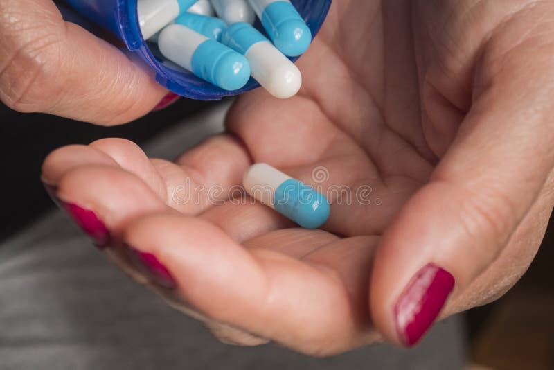 Women Take White and Blue Capsule Stock Photo - Image of prescription ...