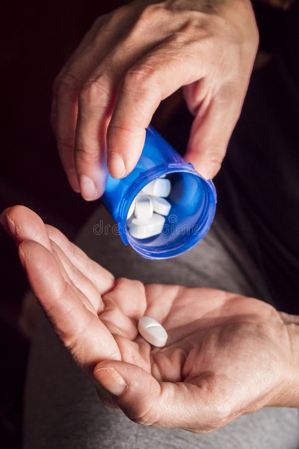 Women Take White Capsule with Right Hand from a Blue Bottle Stock Photo ...