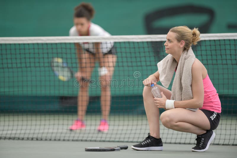 Women Taking Break on Tennis Court Stock Image - Image of indoor, match ...