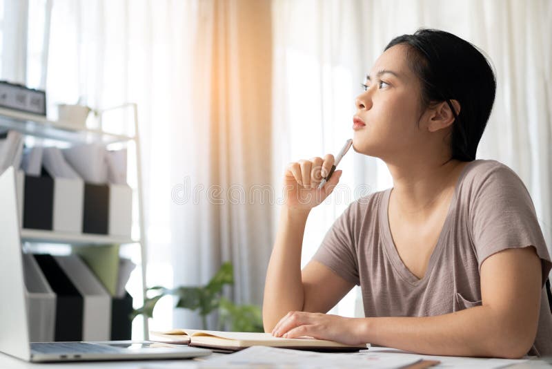 Women is Thinking while Writing Note with Laptop Stock Image - Image of ...