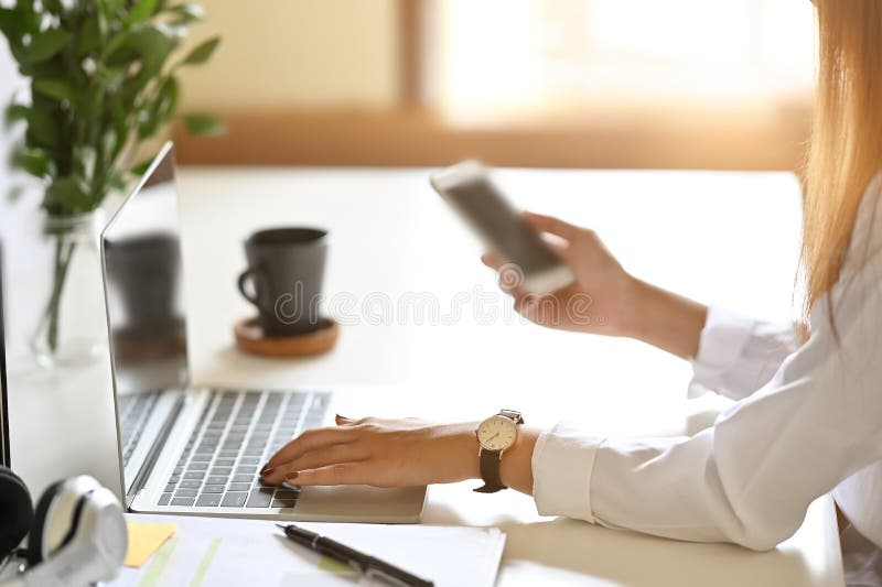 Women Using Laptop and Smartphone on Office Desk Stock Photo - Image of ...