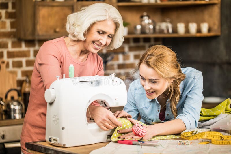 Women using sewing machine stock photo. Image of hair - 88565692