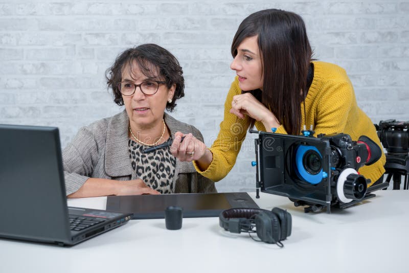Woman Video Editor and Young Assistant Using Graphic Tablet Stock Image ...
