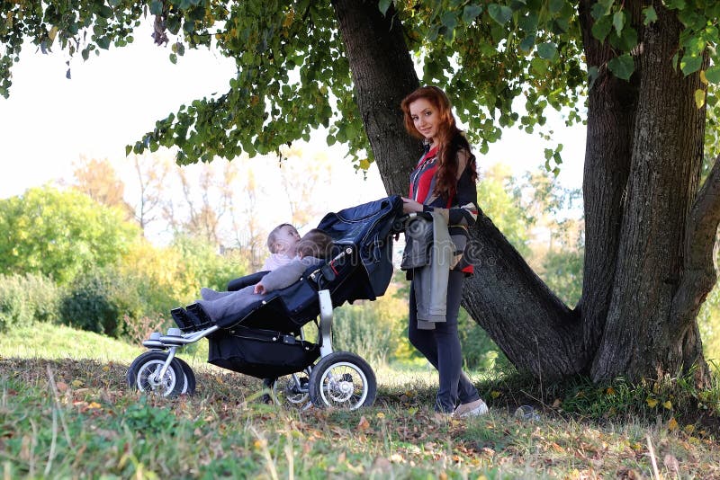 Women walk stroller summer stock image. Image of carriage - 66343751
