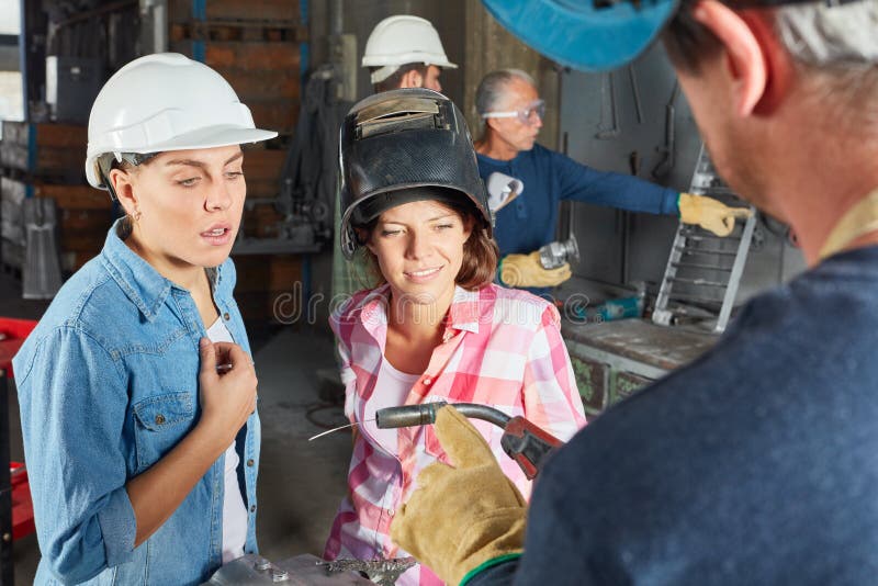 Women in welding lesson stock image. Image of industry - 133656571