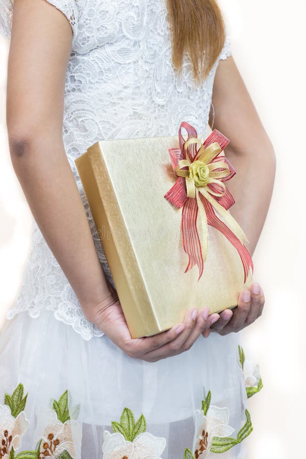 Women in White Hiding a Gift Behind Her Back. Stock Photo - Image of ...