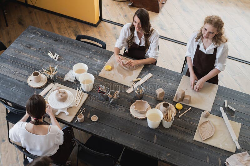 Women Working In Pottery Studio, Smiling And Talking. Ceramic Workshop ...