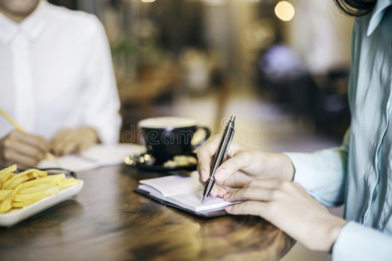 Women Writing Note in a Cafe Stock Image - Image of restaurant, adults ...
