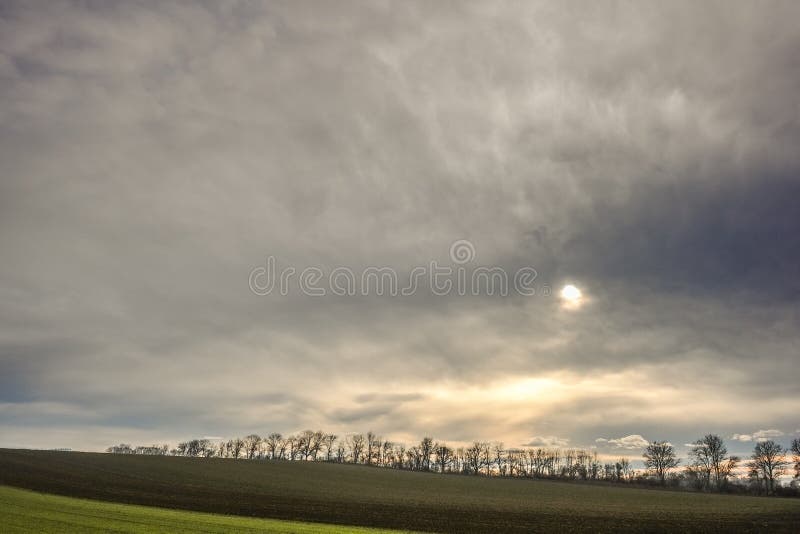 Wonderful Dense Gray Clouds with Sun in a Landscape with Fields Stock ...