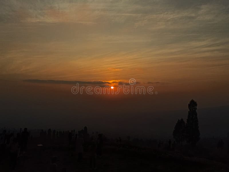 Spectacular Sunset Over Distant Horizon with Silhouetted Trees and Sky ...
