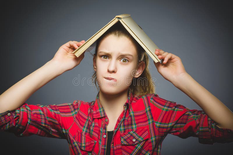 Wondering And Stressed Girl With Book Closeup Teen On Grey Background