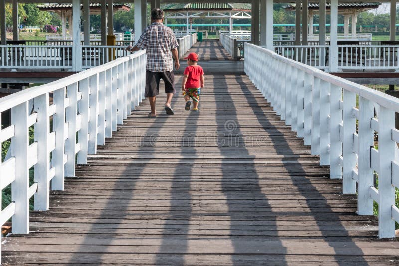 Father and Son Walking on a Wooden Bridge, Outdoor Editorial ...