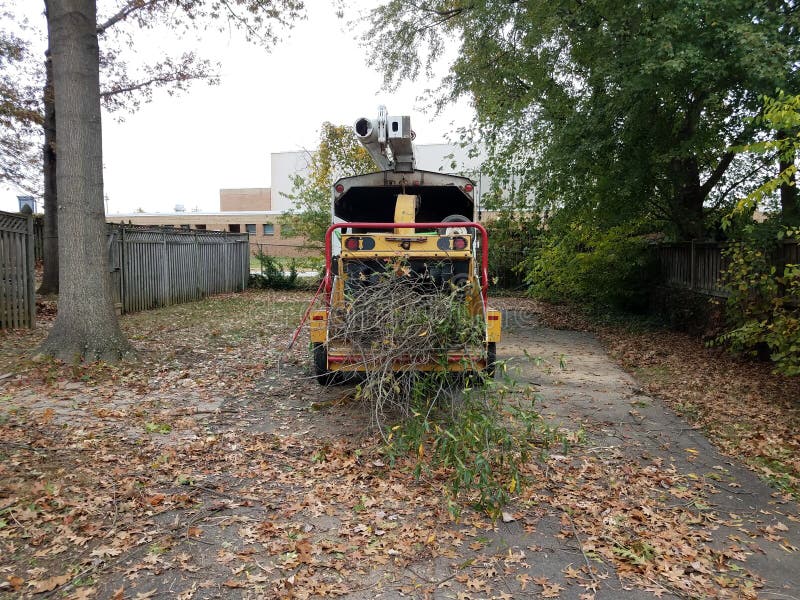 Wood Chipper Machine in Driveway with Tree Branches Stock Photo - Image ...