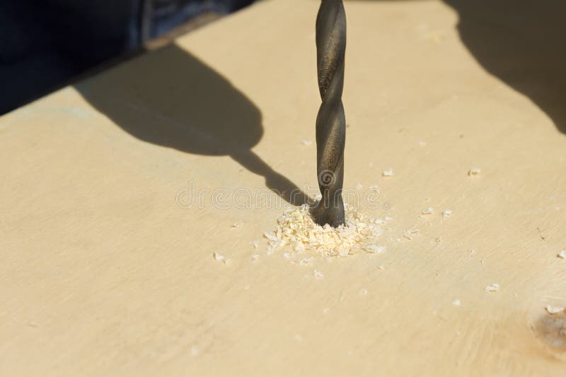 Wood Drill Bit. Drilling Hole in Board Stock Image - Image of hand ...