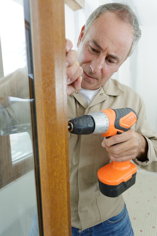 Wood Drilling Machine Drilling on Brown Door Edge Stock Image - Image ...