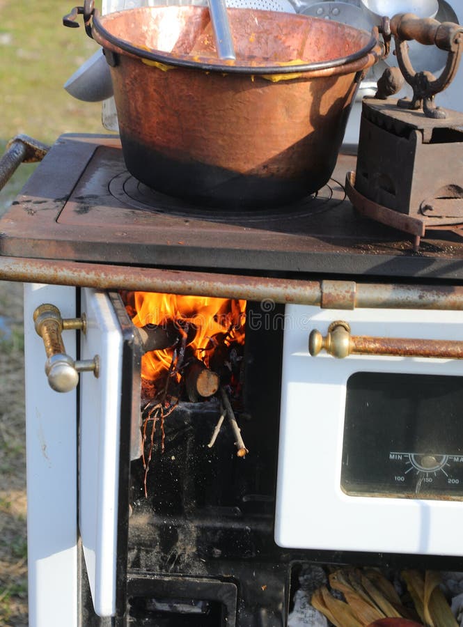 Wood-fired Kitchen Range with a Lit Fire and a Copper Cauldron Above ...