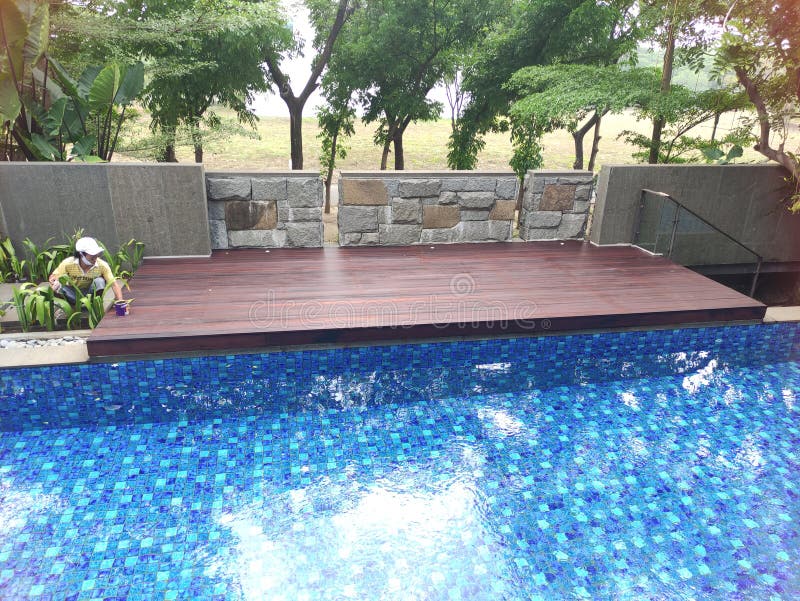 Wood flooring above a pool stock photo. Image of pond - 233899312