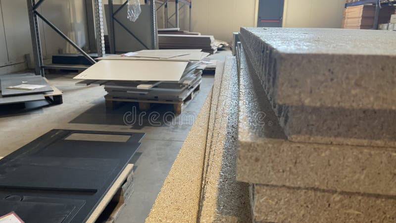Wood Panels and Materials Stacked in a Warehouse during Daylight Hours ...