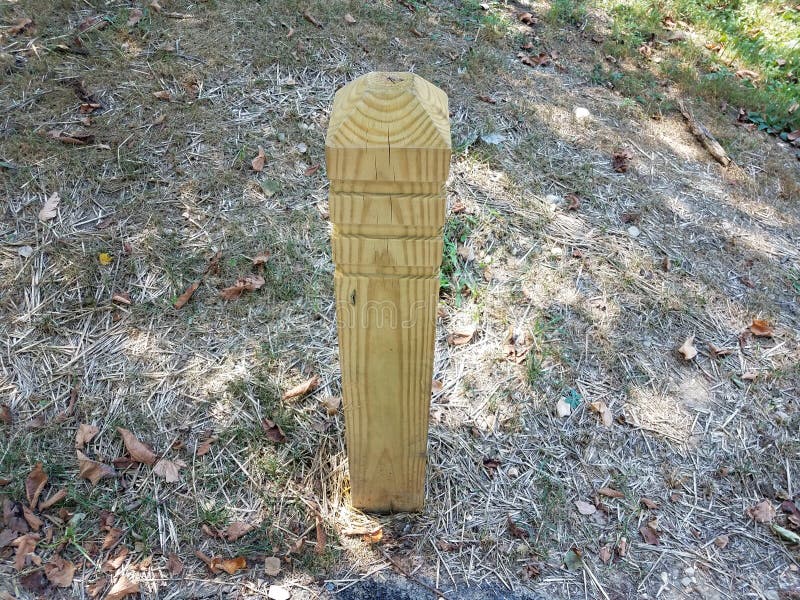 Wood Post or Pole or Bollard in Ground with Straw Stock Image - Image ...