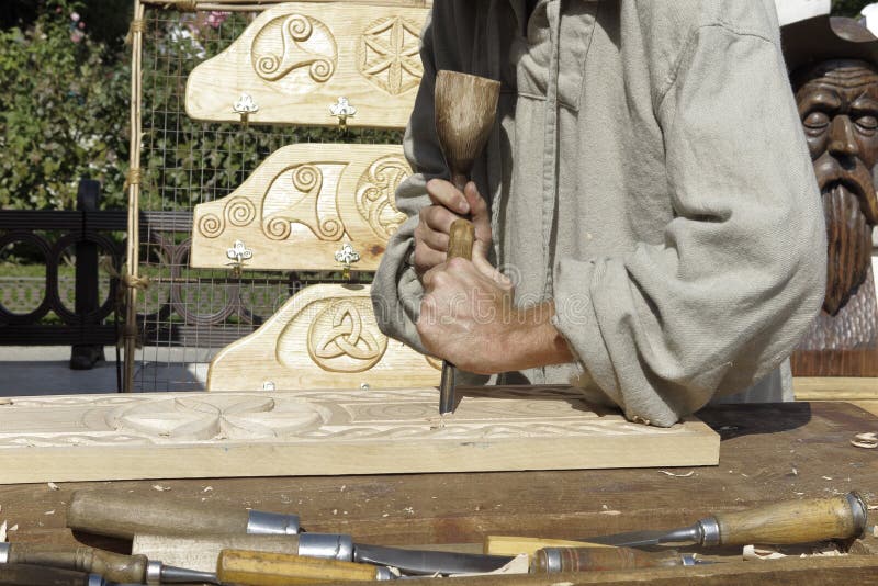 Wood Sculptor at a Workbench Carving a Wooden Figure Stock Photo ...