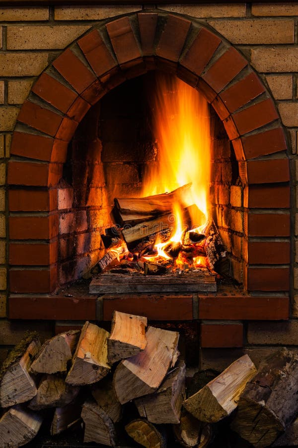 Wood Stack and Logs Burning in Brick Fireplace Stock Image - Image of ...