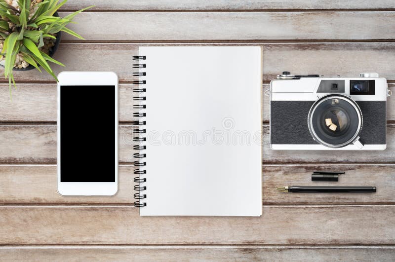 Wood Table with Blank Notebook, Camera, Smartphone and Pen. Top View ...