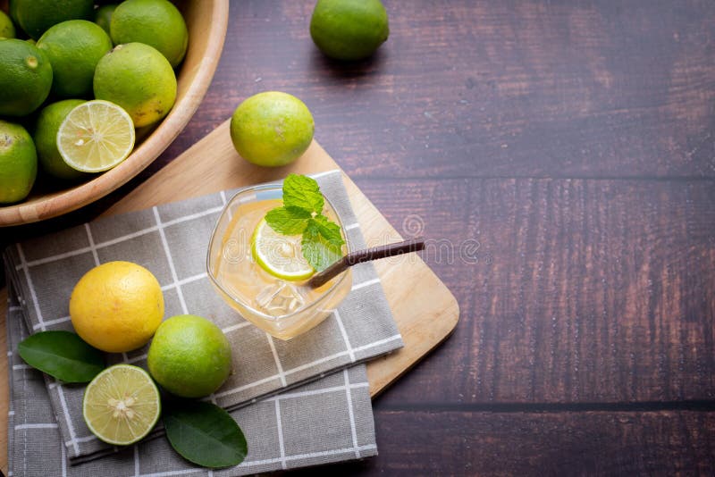 Wood Table with Freshly Squeezed Lemon Juice with Mint and Sliced Lemon ...