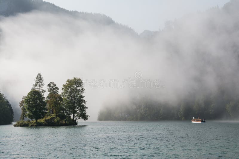 Wooded Island on the Lake in the Clouds Stock Photo - Image of hill ...