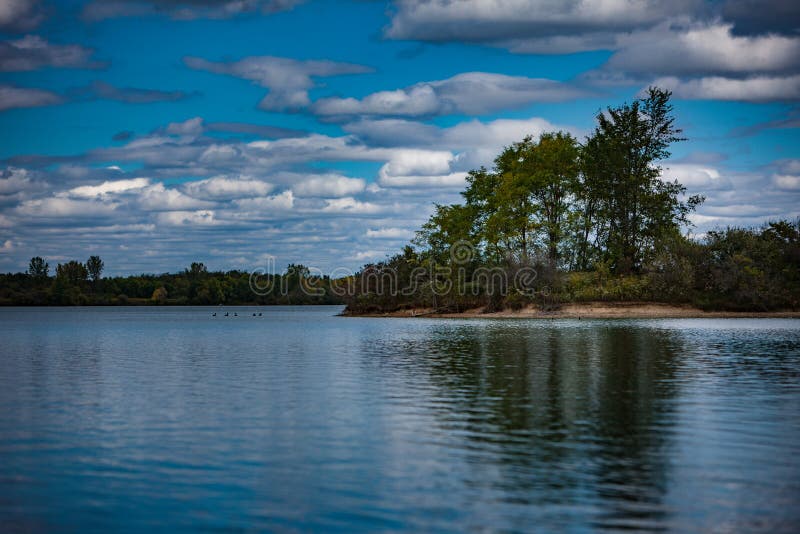 Wooded Island Across a Lake Stock Image - Image of watery, small: 151985325