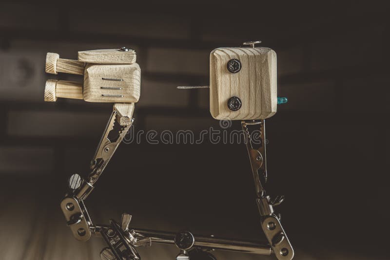 Wooden Robot Android Stands on a Table Under a Magnifying Glass. Stock ...