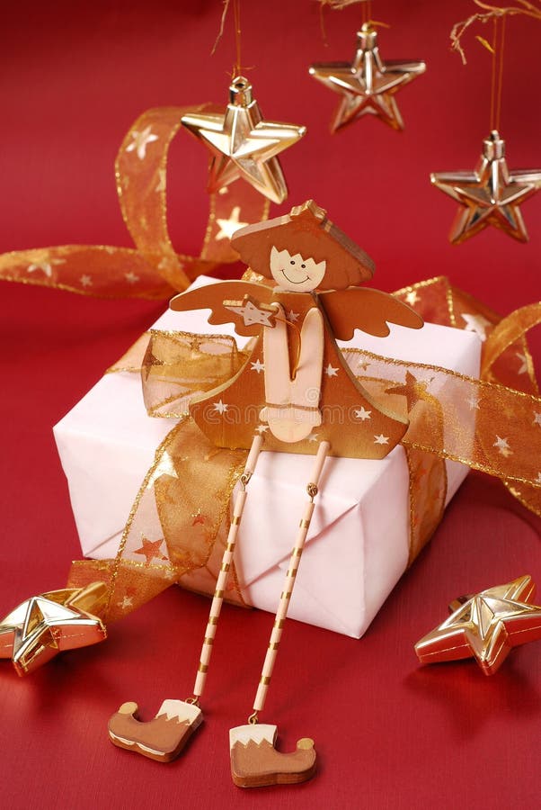 Wooden Angel Sitting on Gift Box Stock Image - Image of wooden, cherub ...