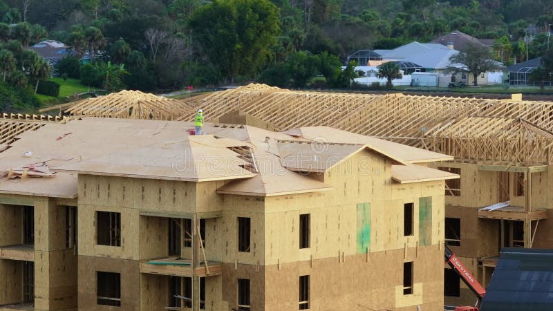 Wooden Apartment Buildings Under Construction with Workers in New ...