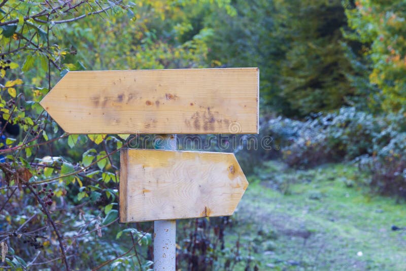 Wooden Arrow Direction Signs in the Forest on a Pillar Stock Photo ...