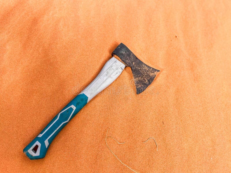 A Wooden Axe Laying on the Sand of a Desert Ground. Tools in Sand Stock ...