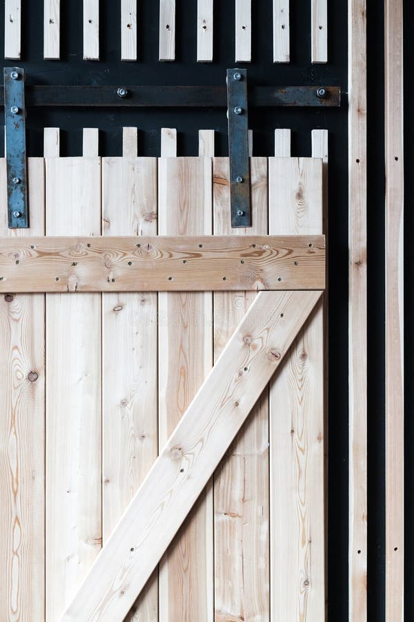 Wooden Barn Door on Rollers in the Loft Style and Rustic Stock Photo ...