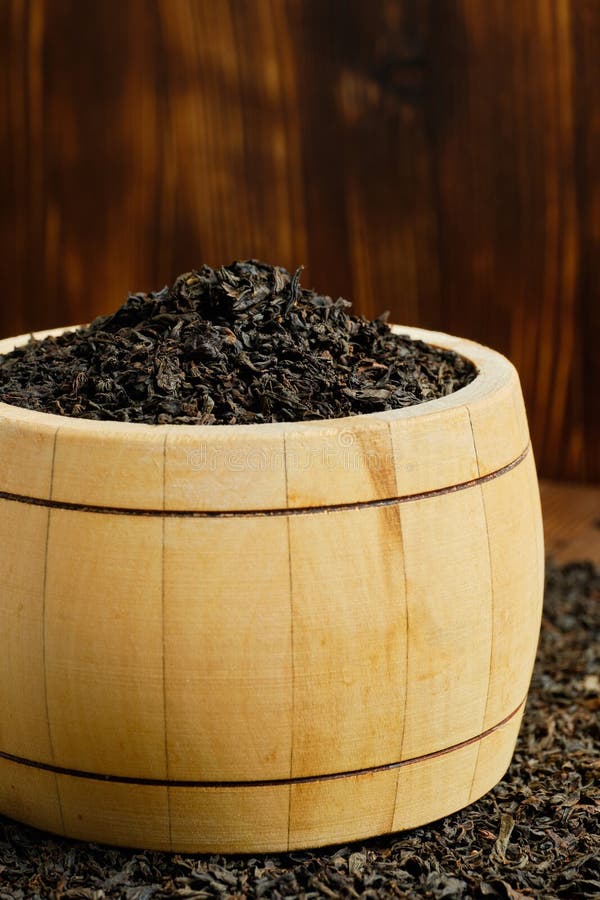Wooden Barrel with Dry Black Tea on a Wooden Background. Packaging ...
