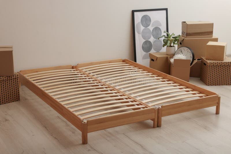 Wooden Bed Frame and Cardboard Boxes on Floor in Room Stock Photo ...